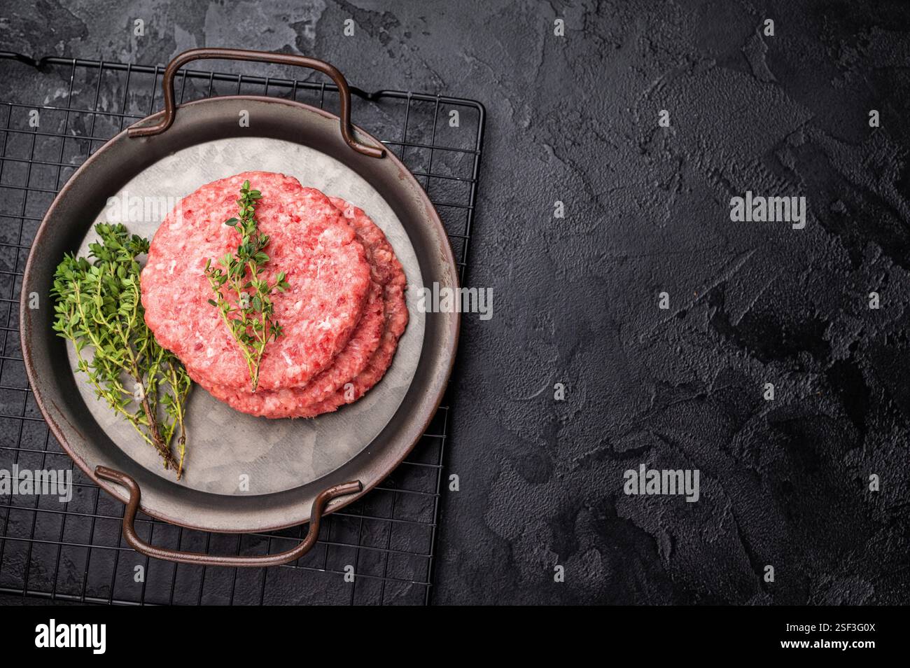 Stack of Raw meat patties, cutlets, chopped meat for burgers in stell ...