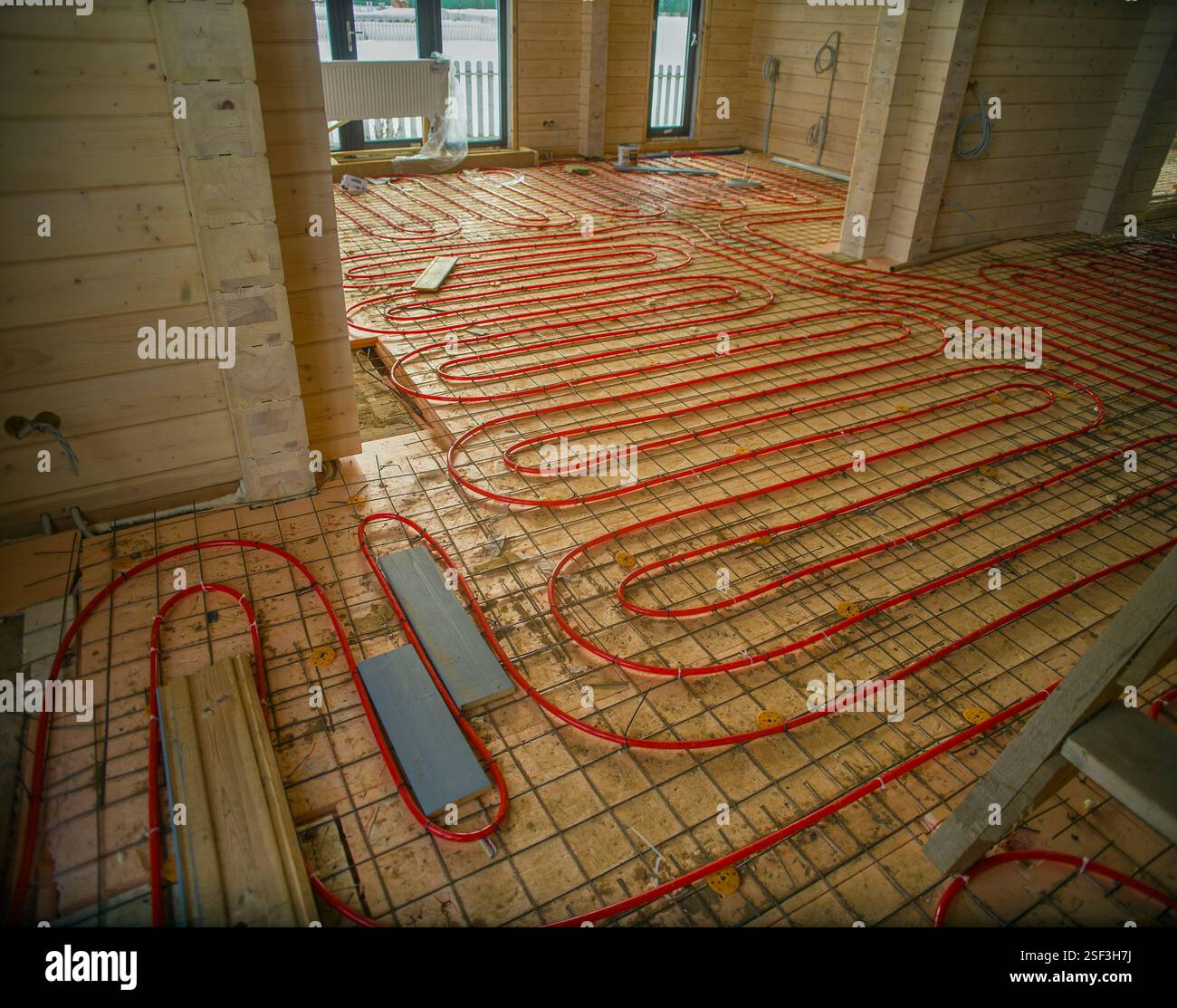 installing a floor heating system in modern wooden house, indoor shot ...