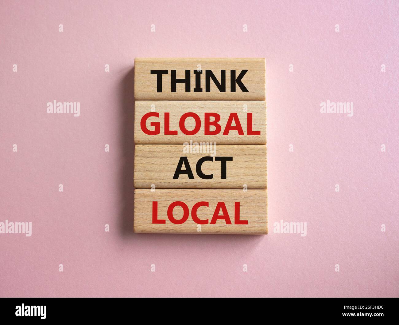 Think global act local symbol. Wooden blocks with words Think global ...