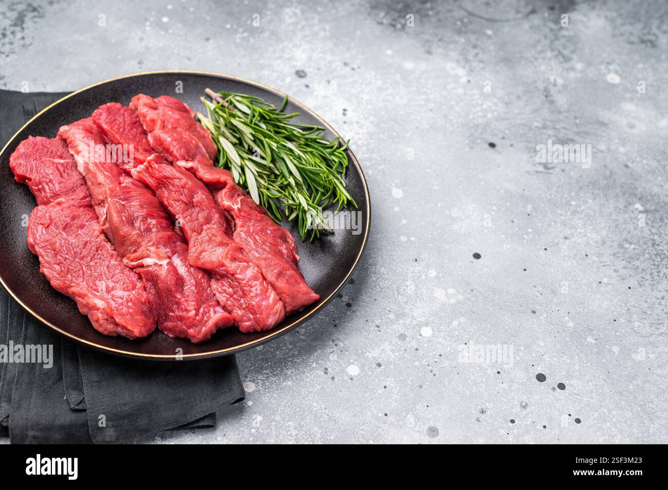 Raw bison meat presented with fresh herbs and spices, inspiring bold ...