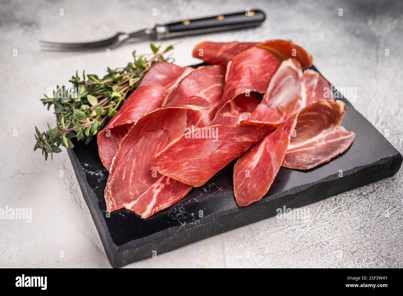 Sliced Speck bacon, Italian cured meat. grey background. top view Stock ...