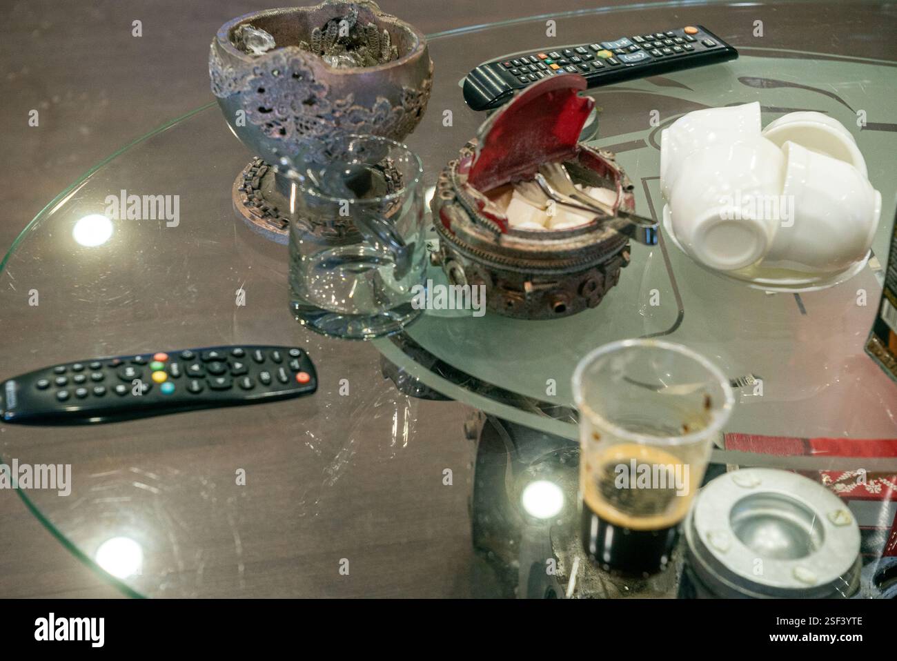 a messy tea rable with two remote controls. indoor close-up Stock Photo ...