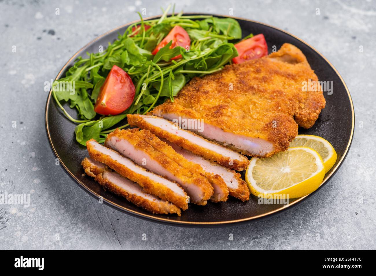 Fried Weiner schnitzel steak, veal breaded meat with salad on a plate ...