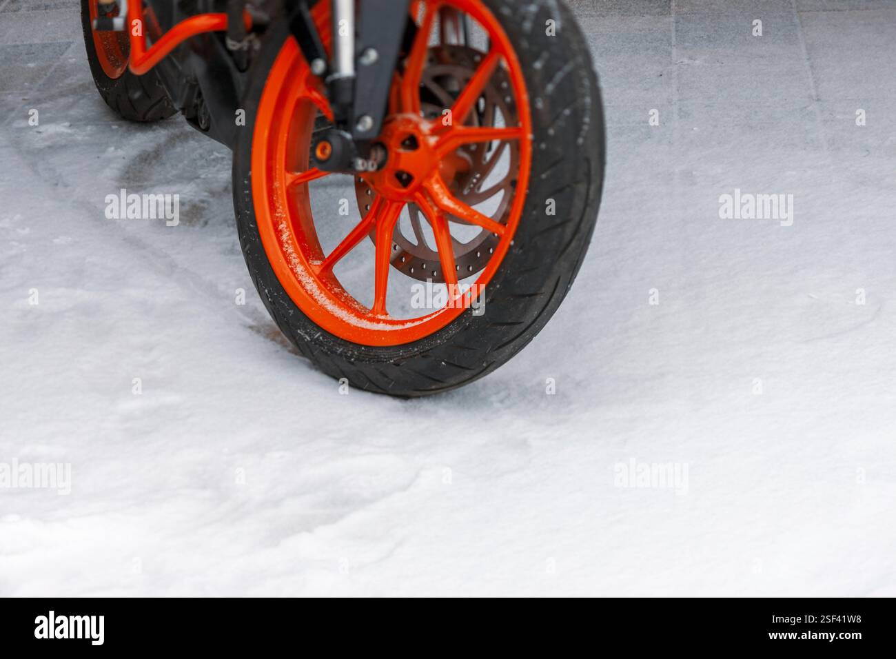 a front wheel of a motorcycle on the snow, street winter scenery Stock ...