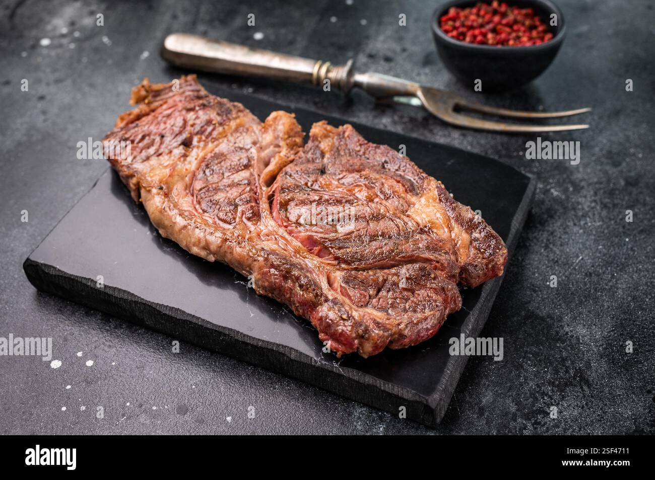 Roasted Chuck eye roll steak, marbled beef meat on a board. black ...