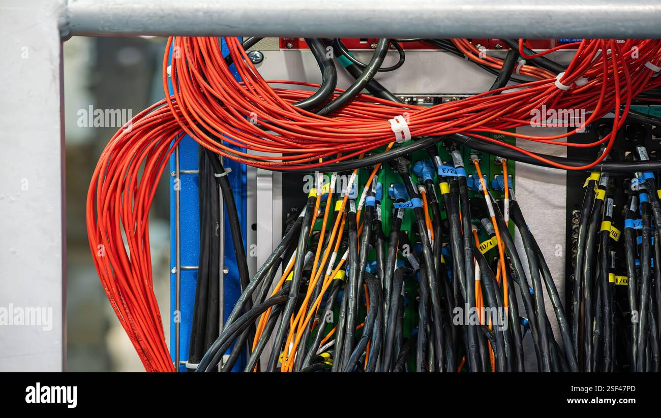 Geneva, Switzerland - February 5, 2025: Neatly bundled cables in an ...