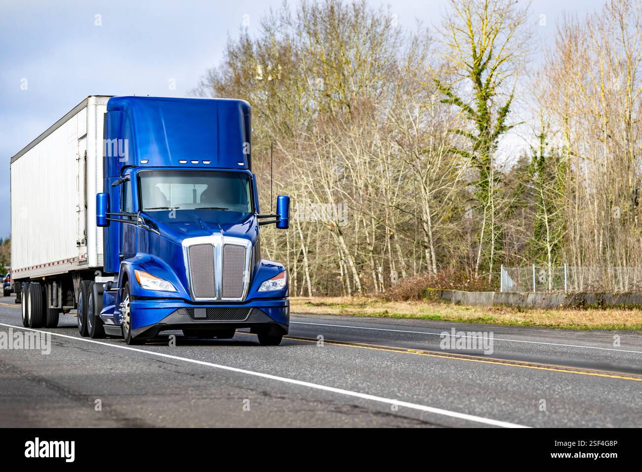 Industrial blue big rig local day cab semi truck with roof spoiler ...