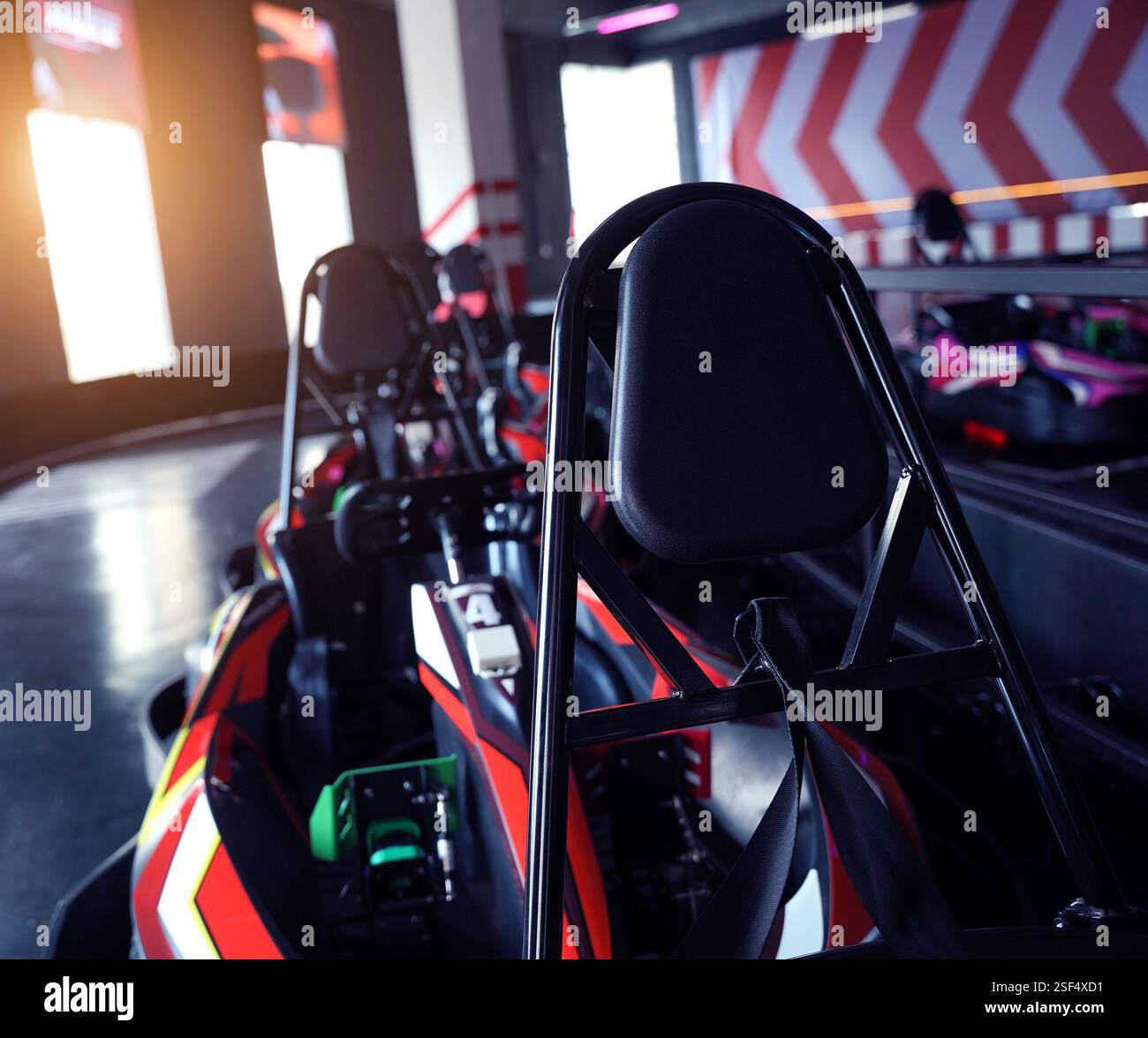 New electric go karts in the modern indoor racing track Stock Photo - Alamy