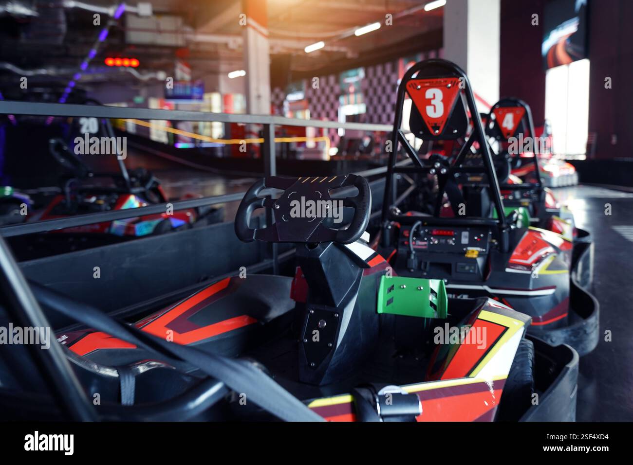 New electric go karts in the modern indoor racing track Stock Photo - Alamy
