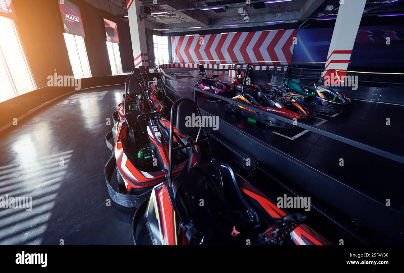 New electric go karts in the modern indoor racing track Stock Photo - Alamy
