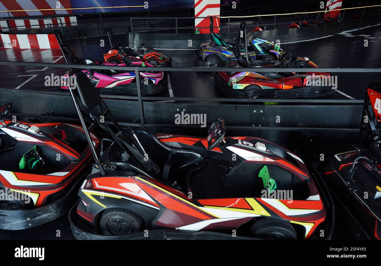 New electric go karts in the modern indoor racing track Stock Photo - Alamy