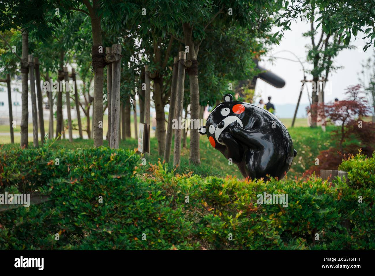 Kumamon, a Mascot from Yatsushiro, Japan. With funny pose in the garden ...