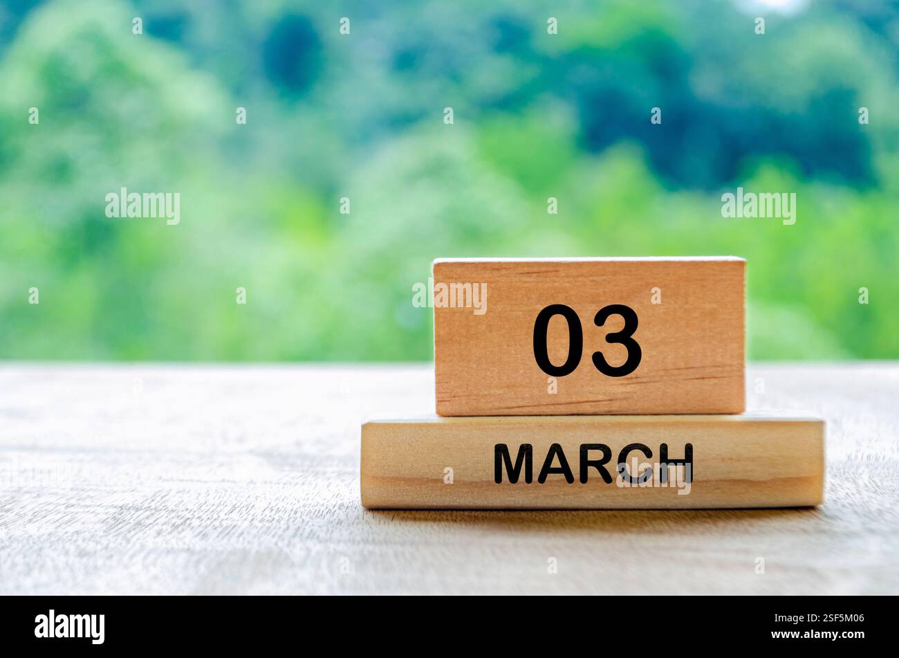 3 March calendar on wooden table with customizable space for text ...
