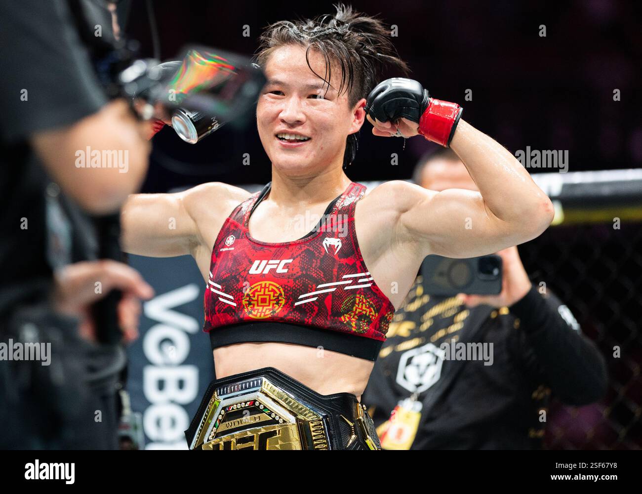 Sydney, Australia. 9th Feb, 2025. Zhang Weili (L) of China celebrates ...