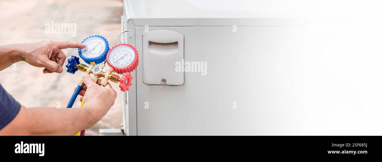 Air conditioning, HVAC service technician using gauges to check ...