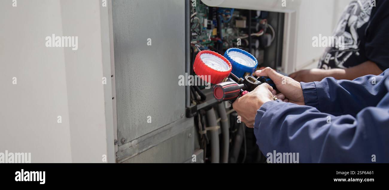 Air conditioning, HVAC service technician using gauges to check ...