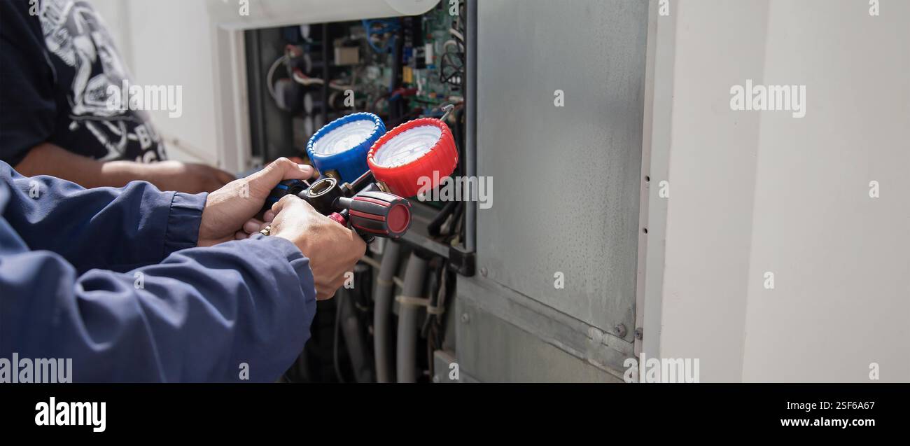 Air conditioning, HVAC service technician using gauges to check ...