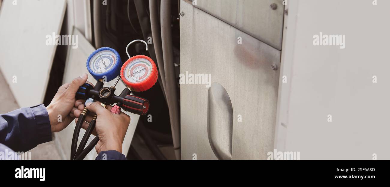 Air conditioning, HVAC service technician using gauges to check ...