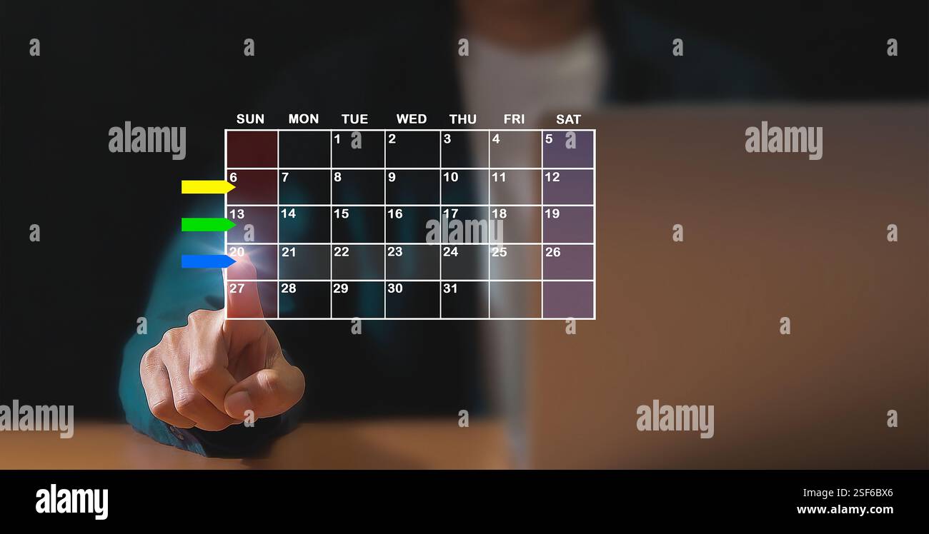 Businessman uses index finger to set agenda on calendar as appointment ...
