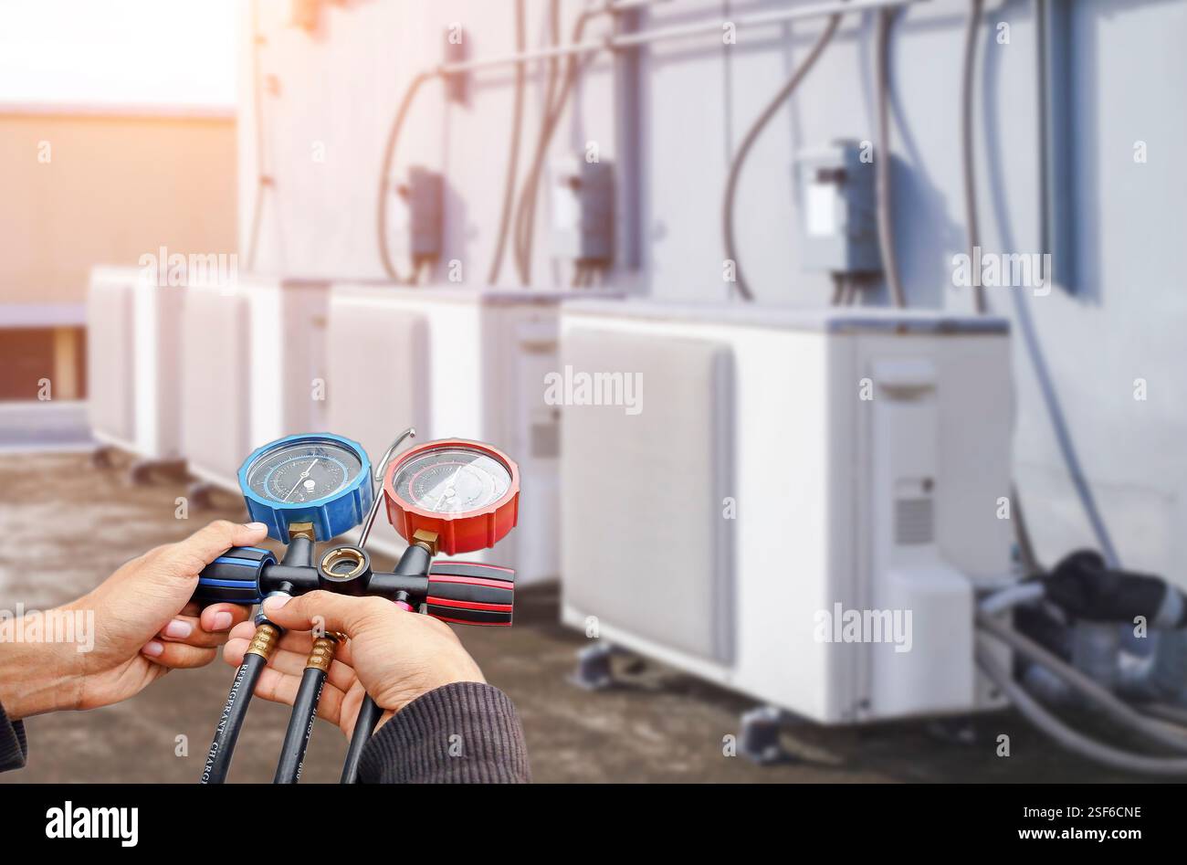 Air conditioning, HVAC service technician using gauges to check ...