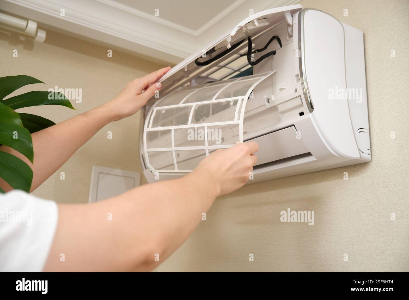 Cleaning air conditioner filter. Close-up of person removing dust ...