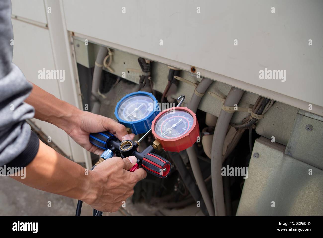 Air conditioning, HVAC service technician using gauges to check ...