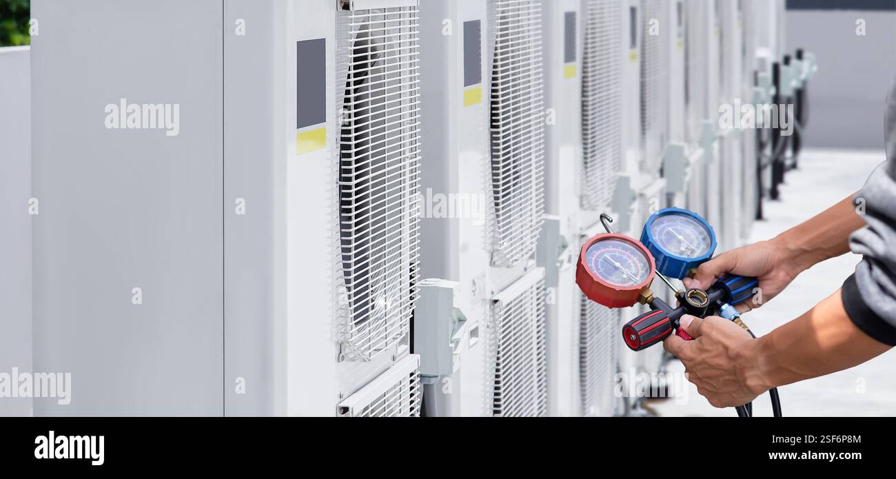 Air conditioning, HVAC service technician using gauges to check ...