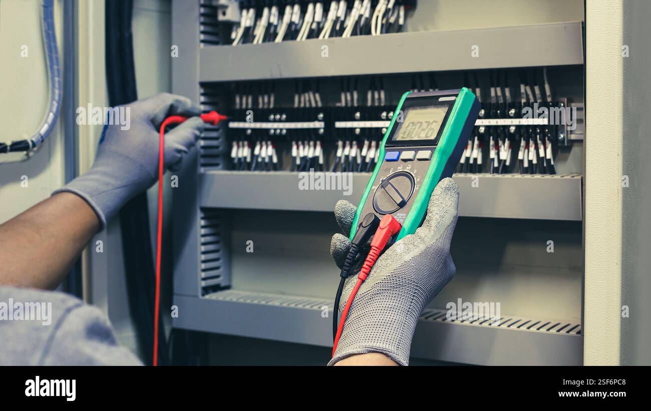 Electrical engineer inspects electrical control equipment Stock Photo ...