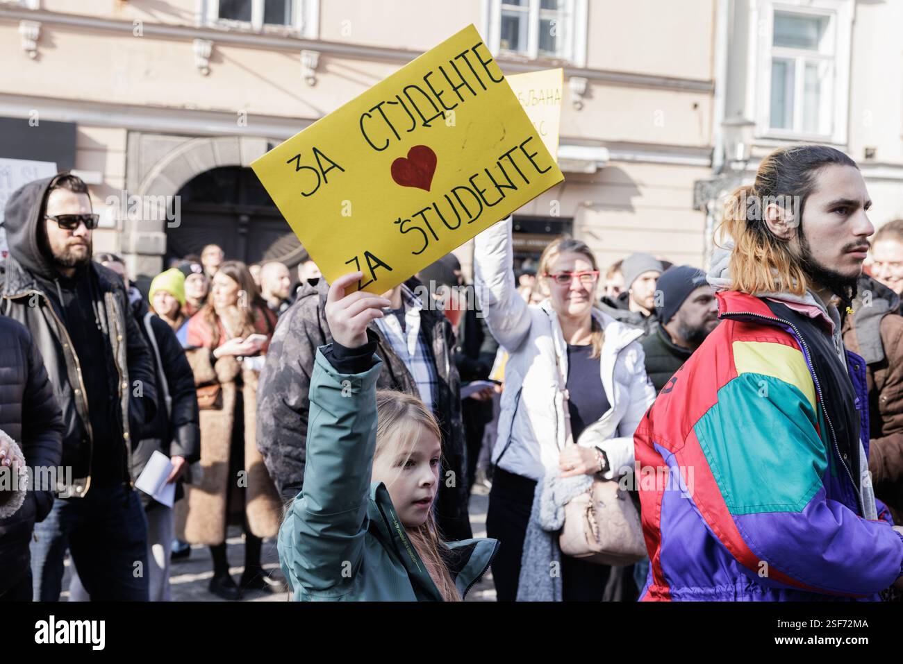 A girl holds up a placard that says "For the students" during the ...