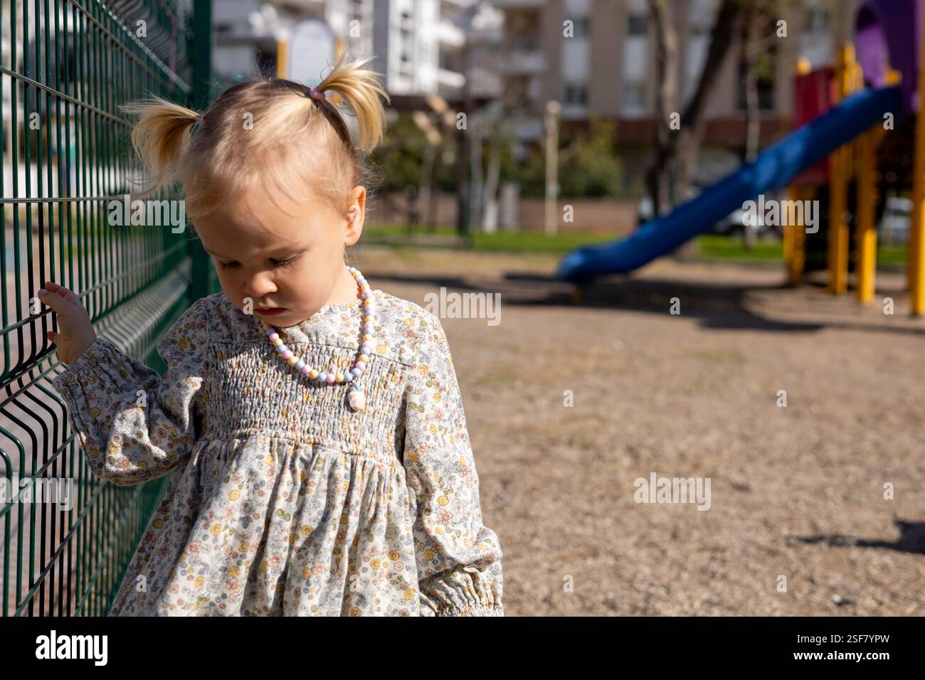 Upset worried girl toddler problem child walking alone on play park ...