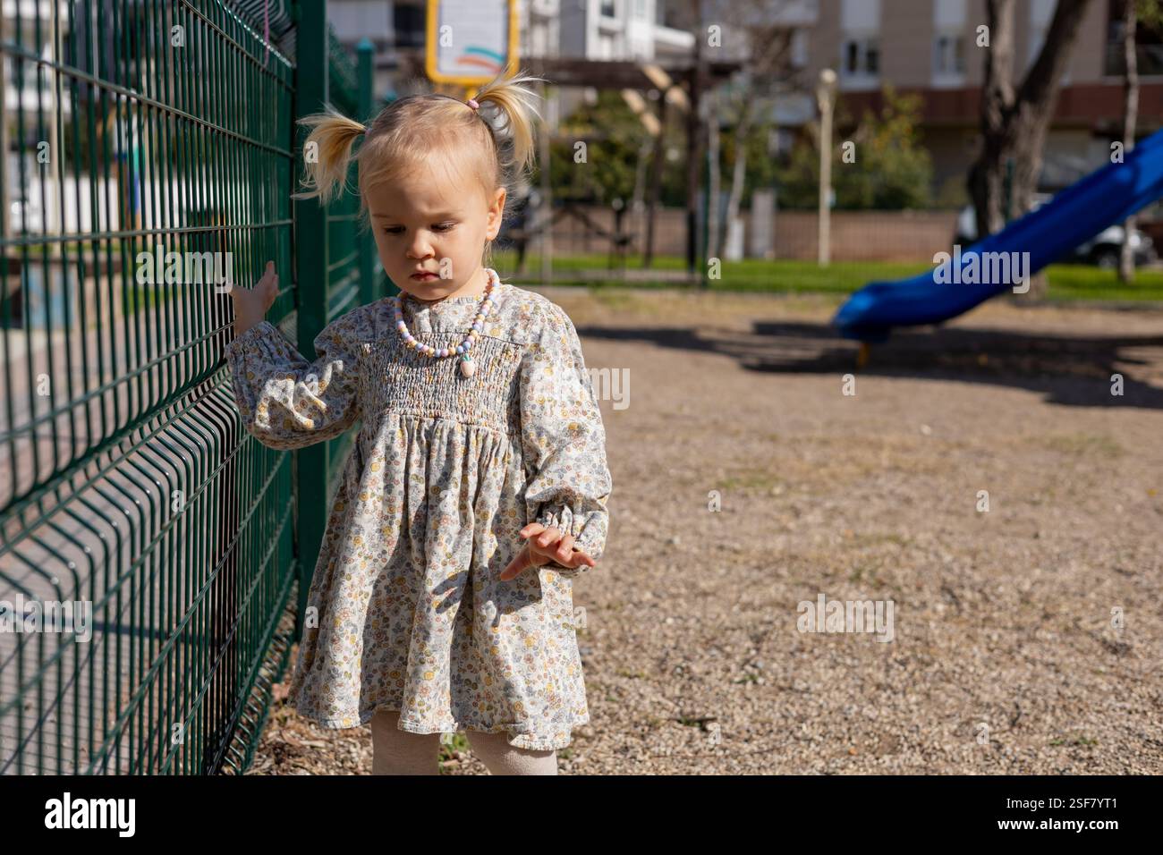 Upset worried girl toddler problem child walking alone on play park ...