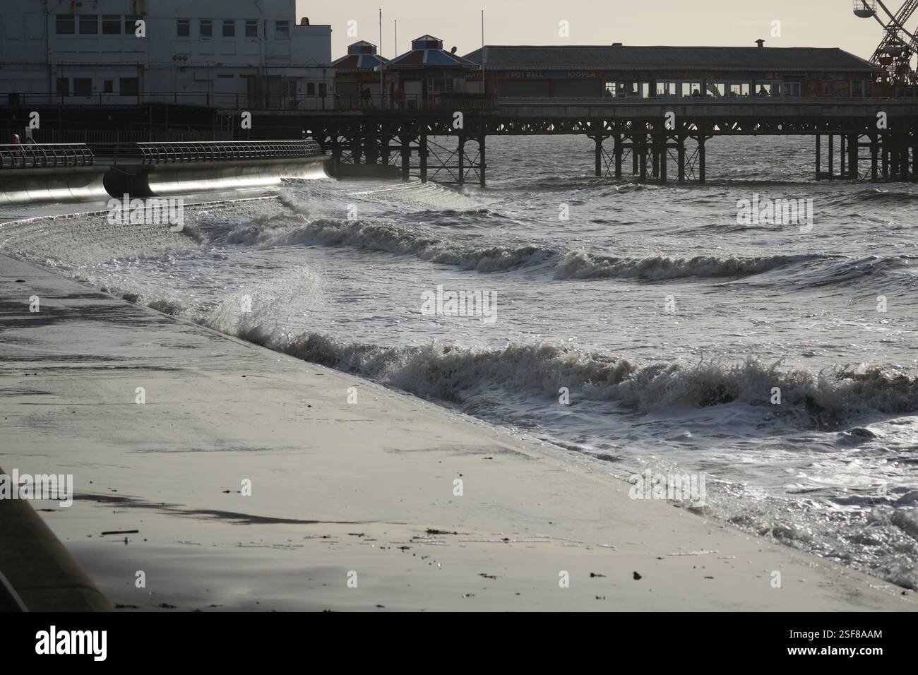 Waves breaking on incoming tide against sea wall in Blackpool England ...