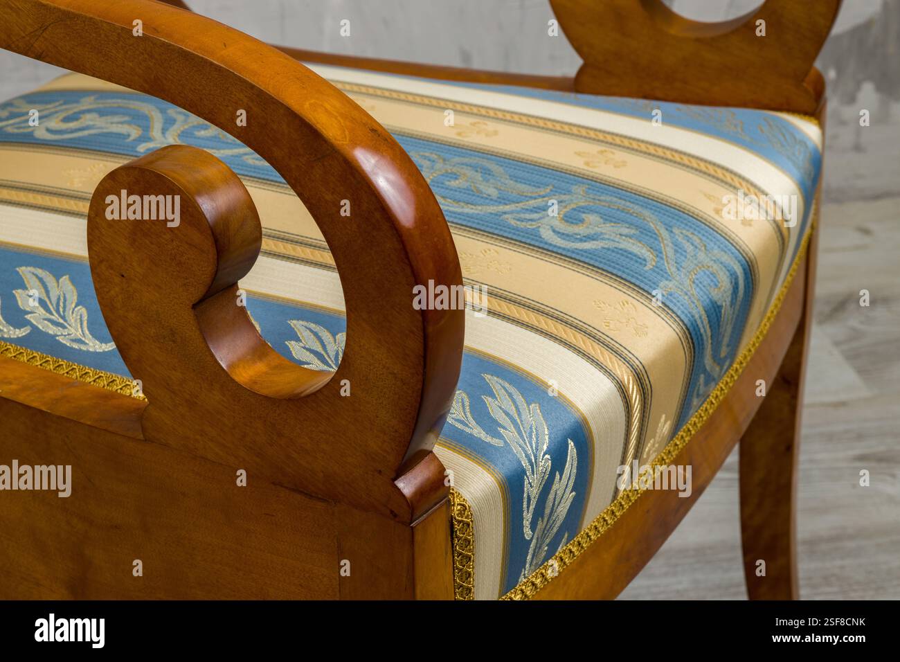 Biedermeier-style armchair in a room setting with a textured wall and ...