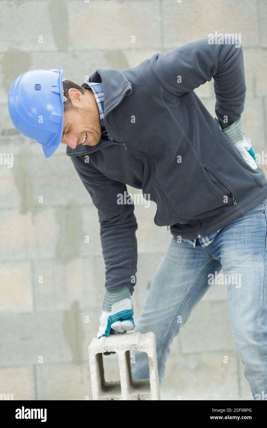 construction worker getting back injury Stock Photo - Alamy