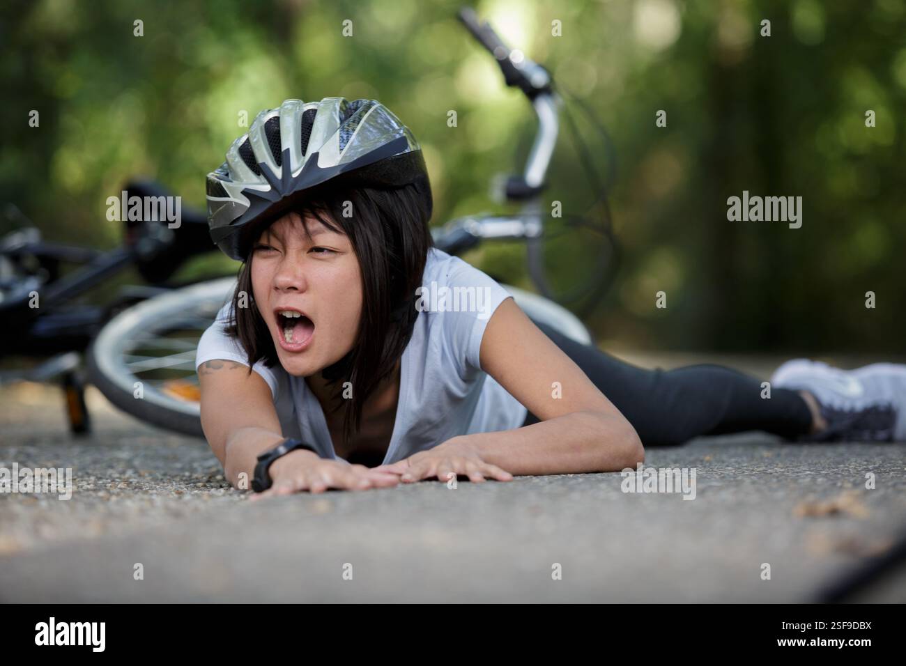 asian woman fallen from her bicycle Stock Photo - Alamy