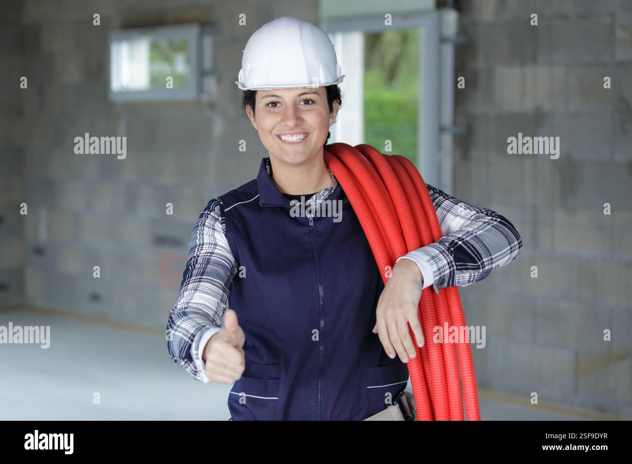 young female engineer with pipe on her shoulder Stock Photo - Alamy