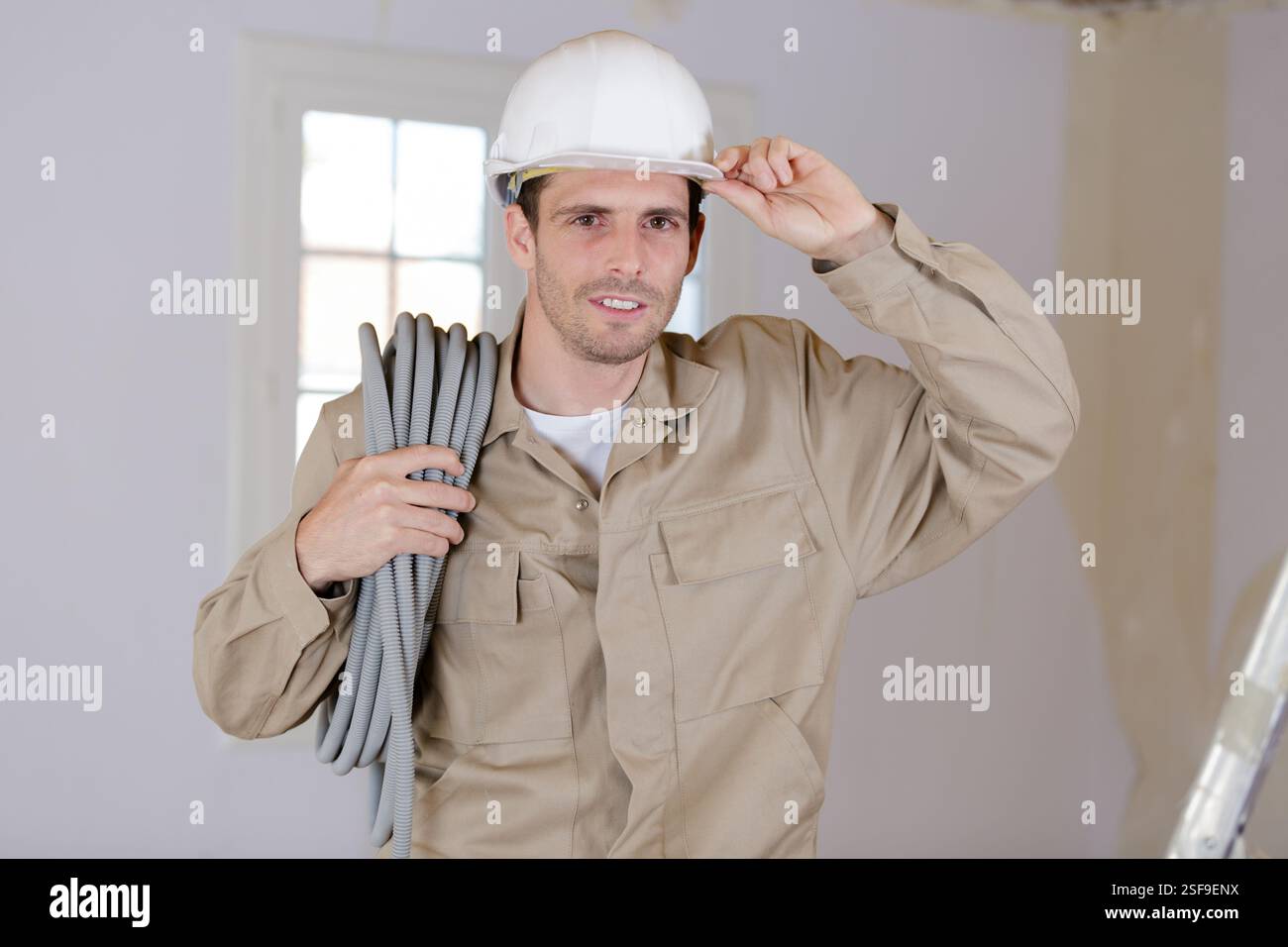 worker with work wear and cable Stock Photo - Alamy