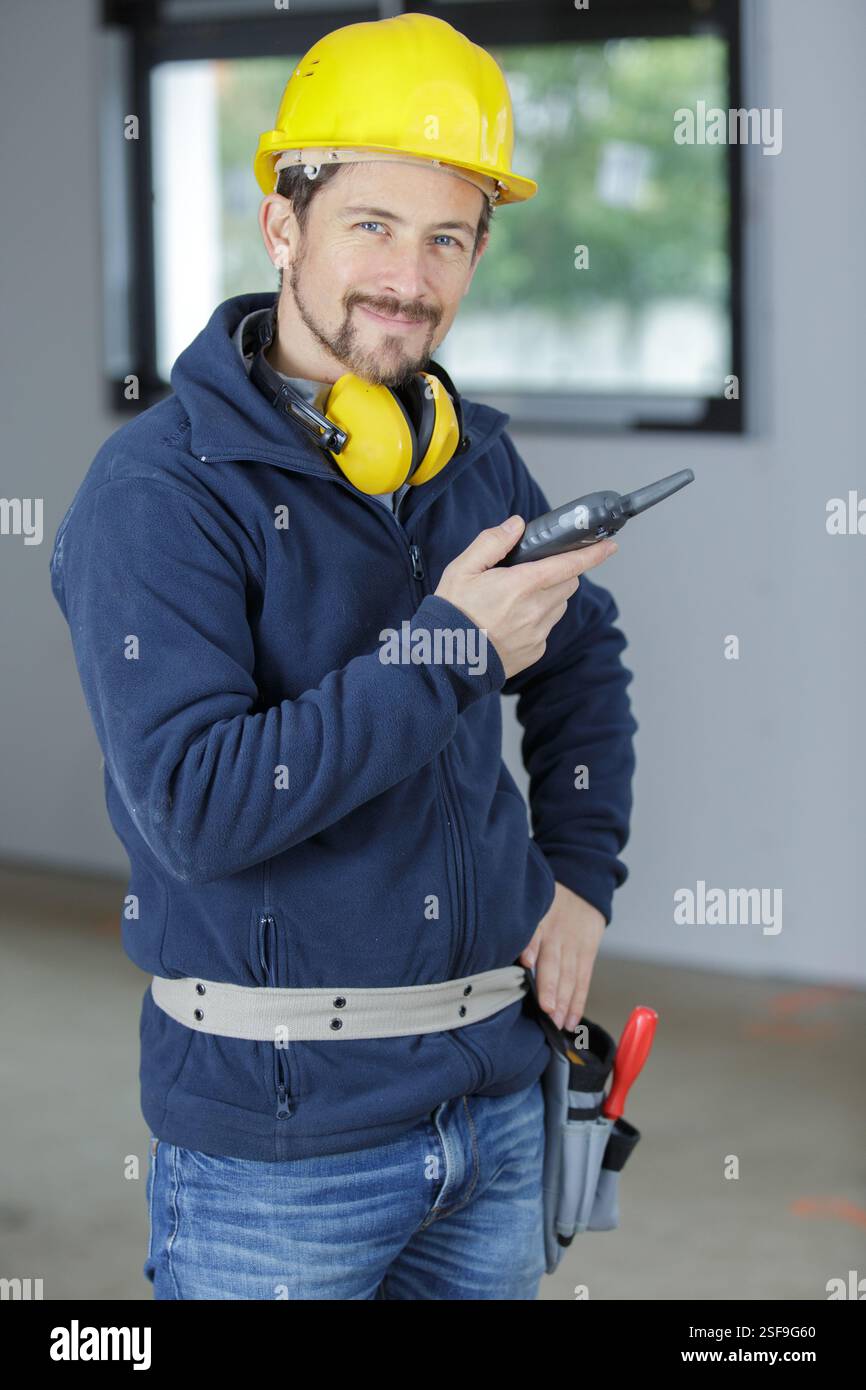 construction worker using walkie-talkie Stock Photo - Alamy