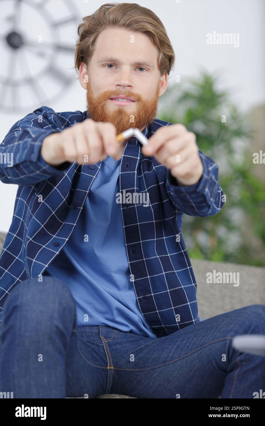 man breaking cigarette Stock Photo - Alamy