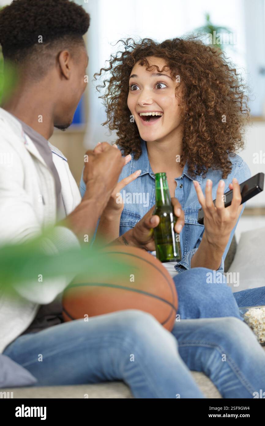 basketball fans couple talking excitedly Stock Photo - Alamy