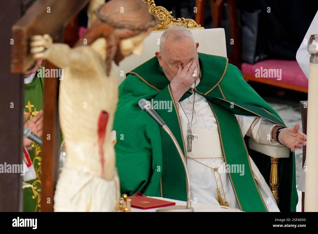 Pope Francis touches his eyes as he presides over a mass for the ...