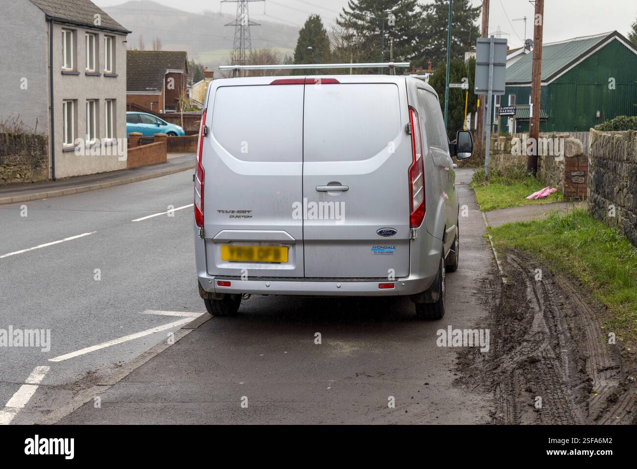 Van parked on pavement obstructing pedestrian walking, LLanfoist, Wales ...