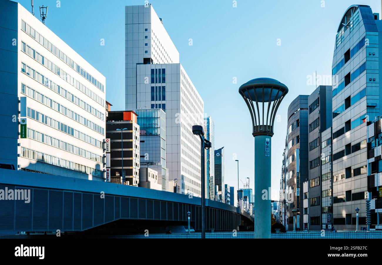 A bright afternoon view of a modern urban streetscape in Taito Ward ...
