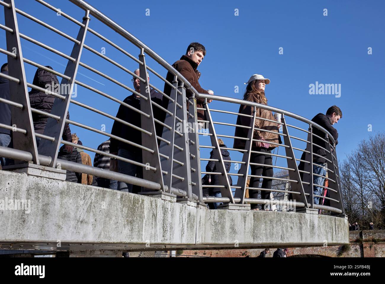 People overlooking the view from a raised platform with guardrail at ...