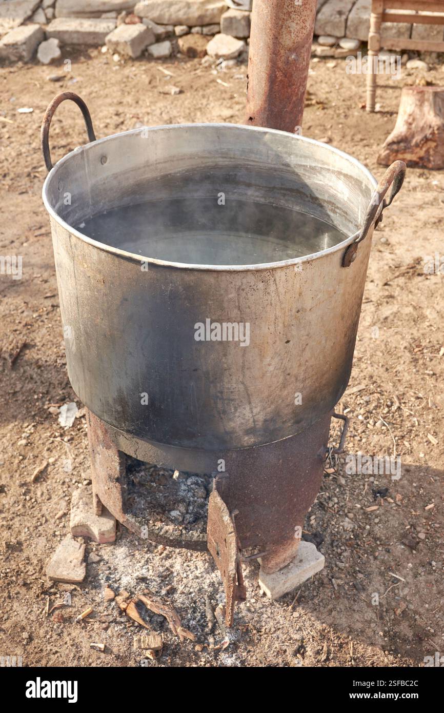 Aluminum pot of water on fire in the yard in the country Stock Photo ...