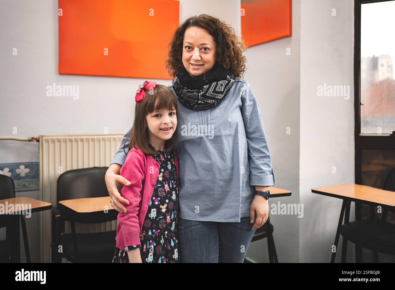 Female teacher with elementary student at language school class Stock ...