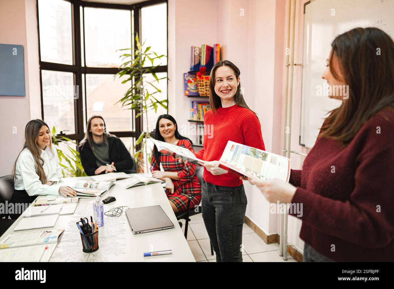 Two female students reading at language school Stock Photo - Alamy