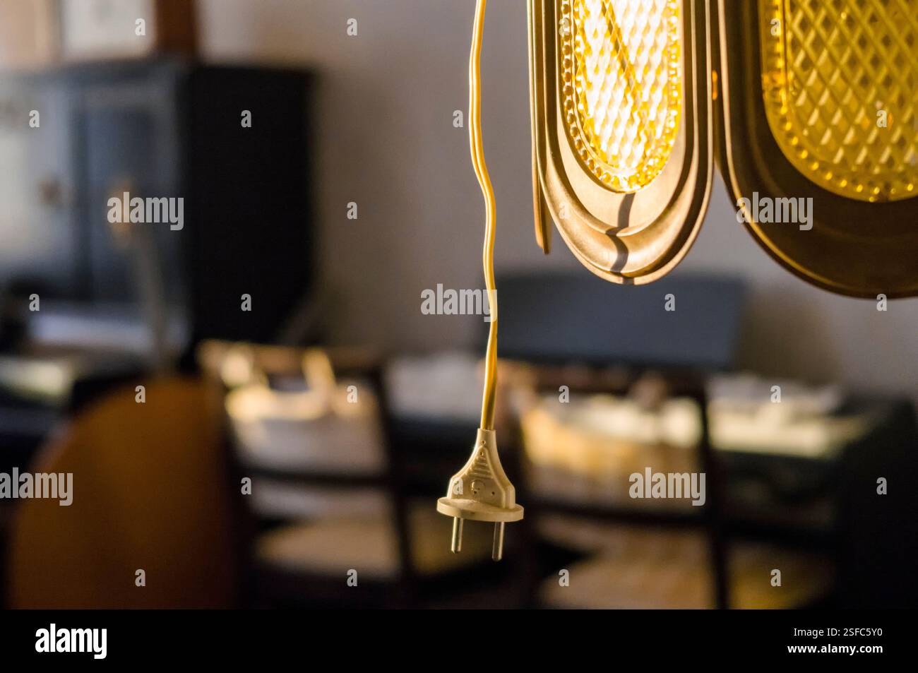 old electric plug hanging on a lamp, indoor shot Stock Photo - Alamy