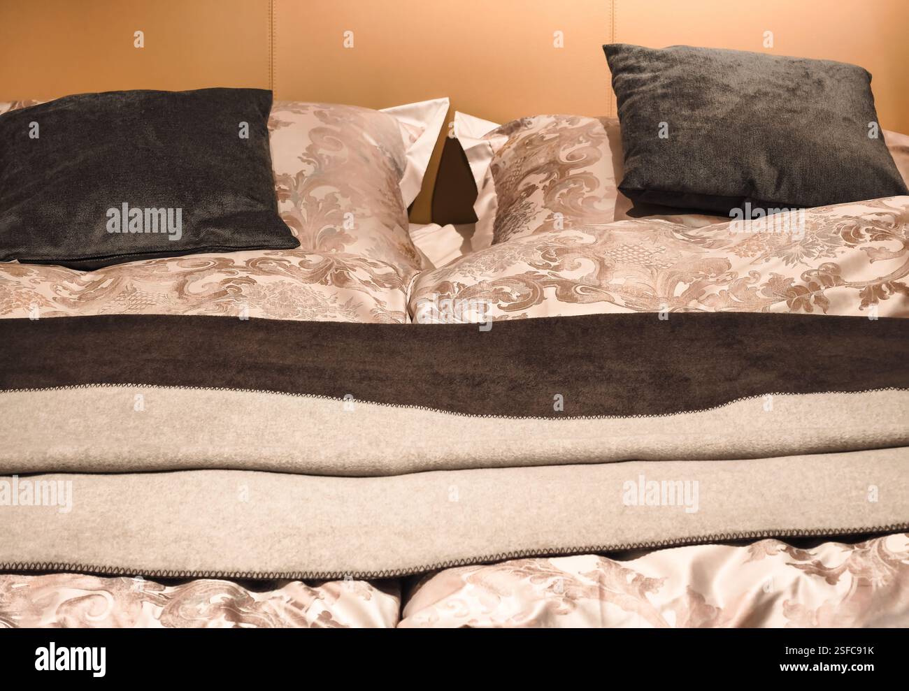 Bed with colorful pillows and floral pattern, close-up. Comfortable ...