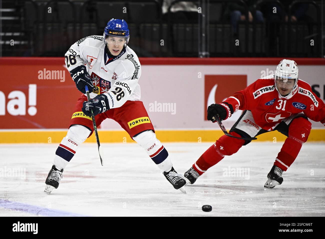 Czechia's Jiri Tichacek #26 and Switzerland's Justin Sigrist #31 during Sunday's ice hockey ...